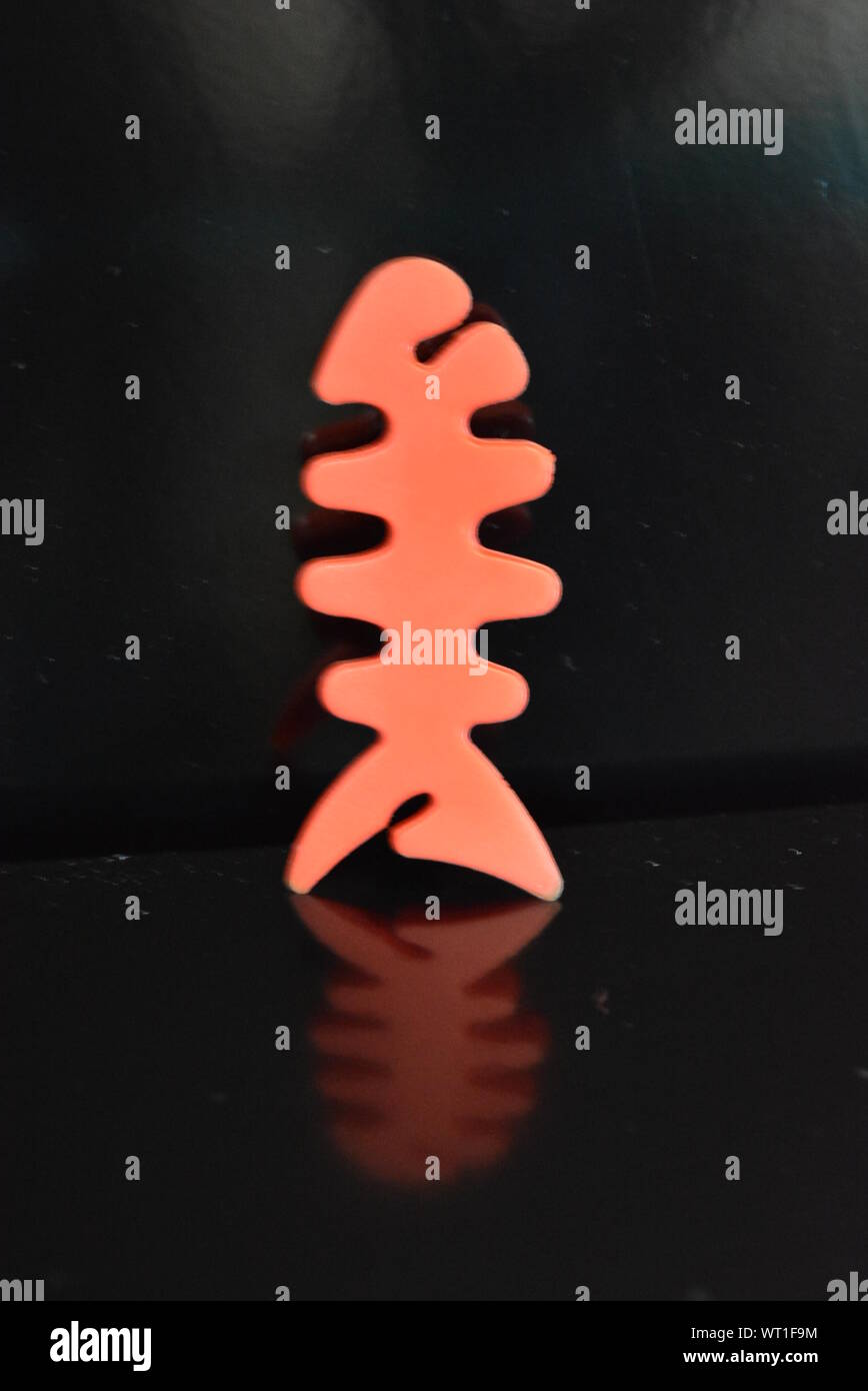 Red rubber plastic fish for wrapping headphones and a headset, reducing ...