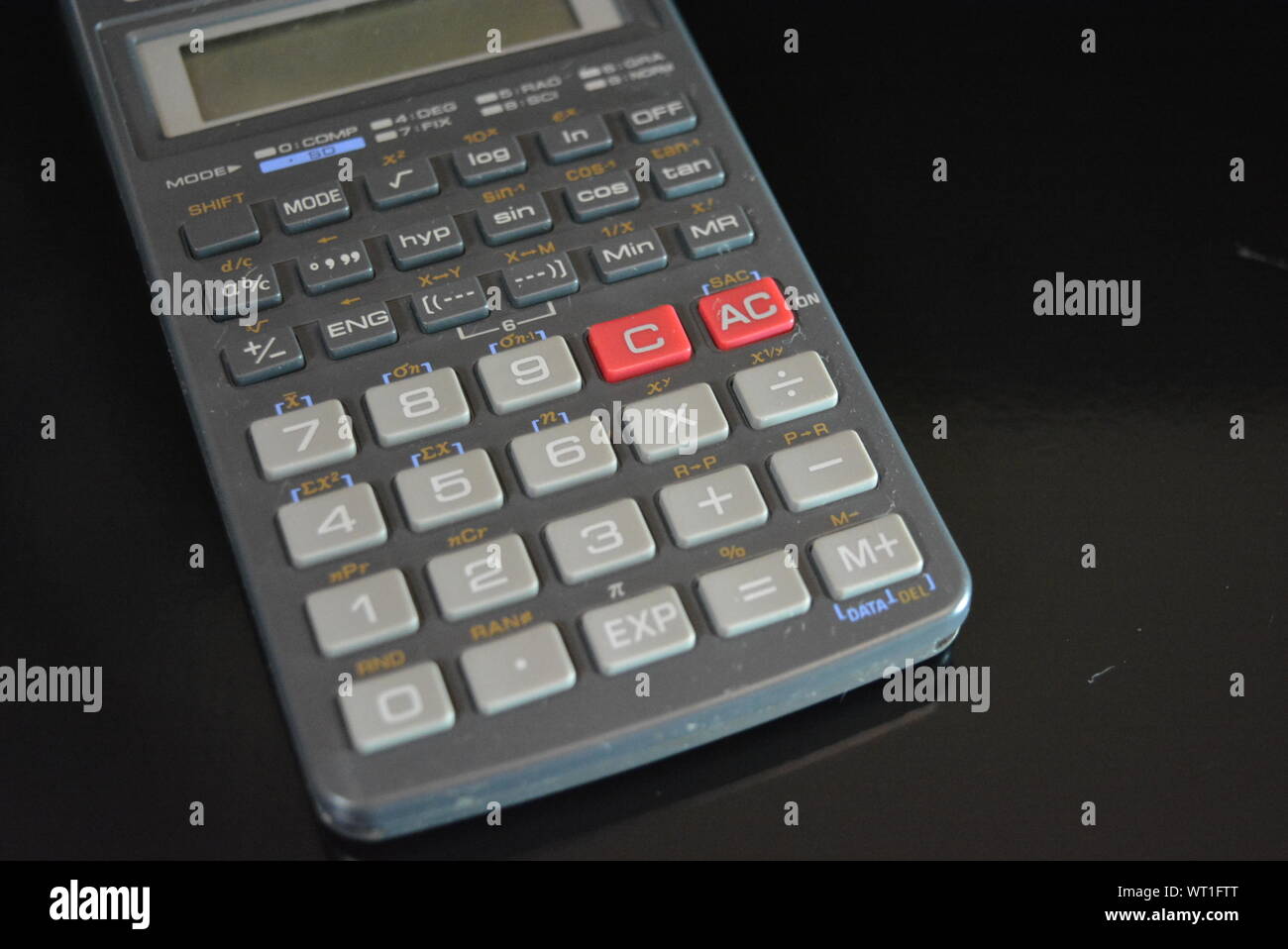 A gray calculator made of quality plastic with beautiful colors located ...