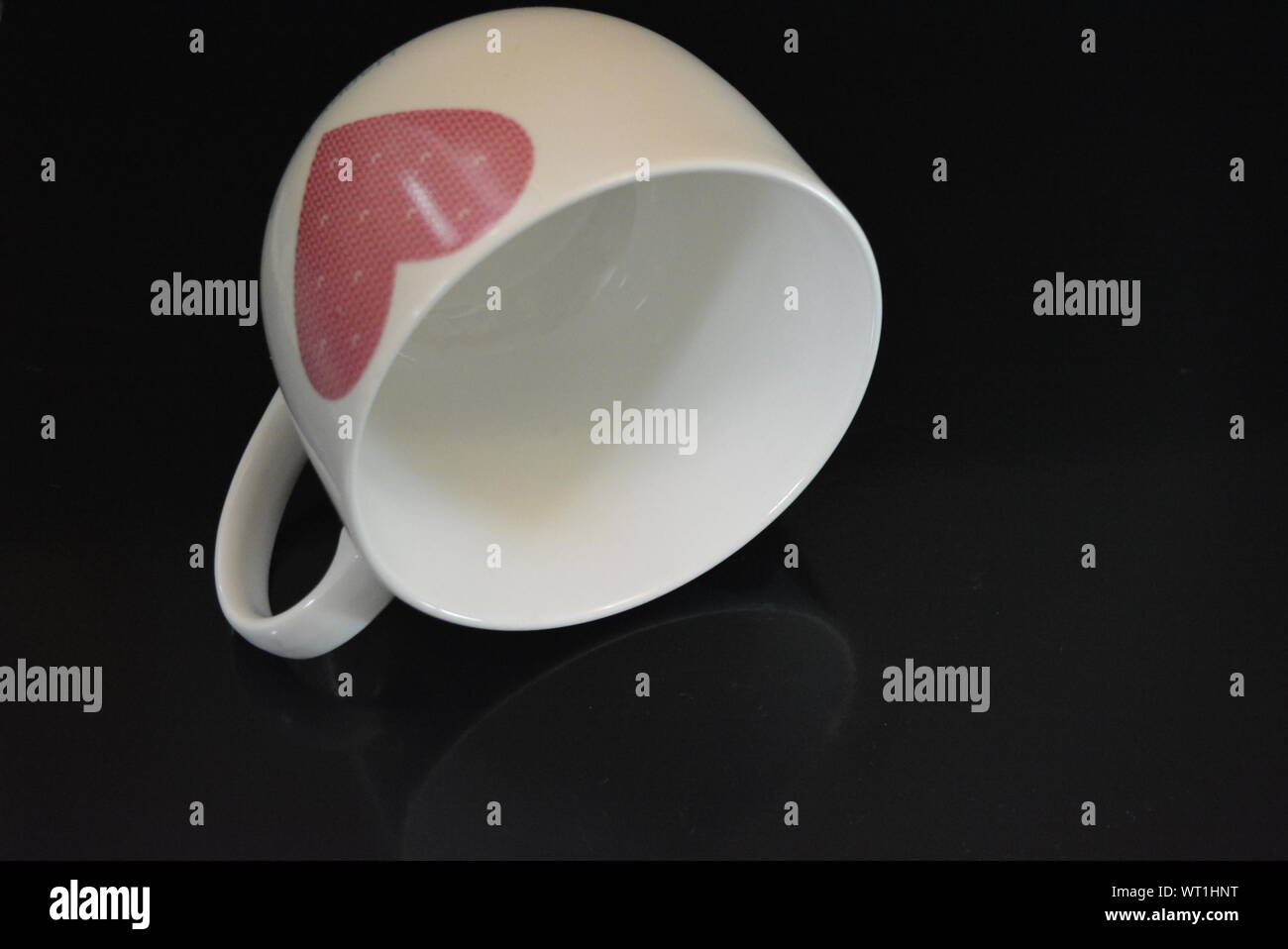 A large white ceramic cup, a pink basin for drinks, is located on a ...