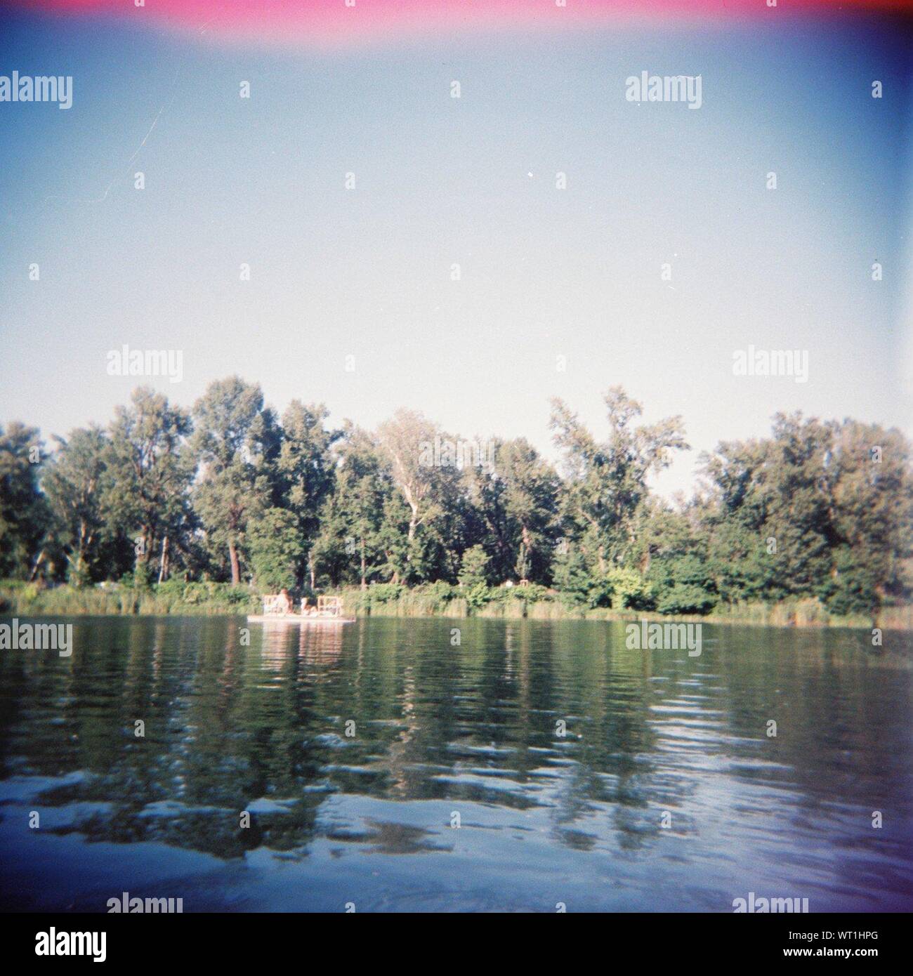 Riverside With Trees On The Opposite Side Stock Photo - Alamy