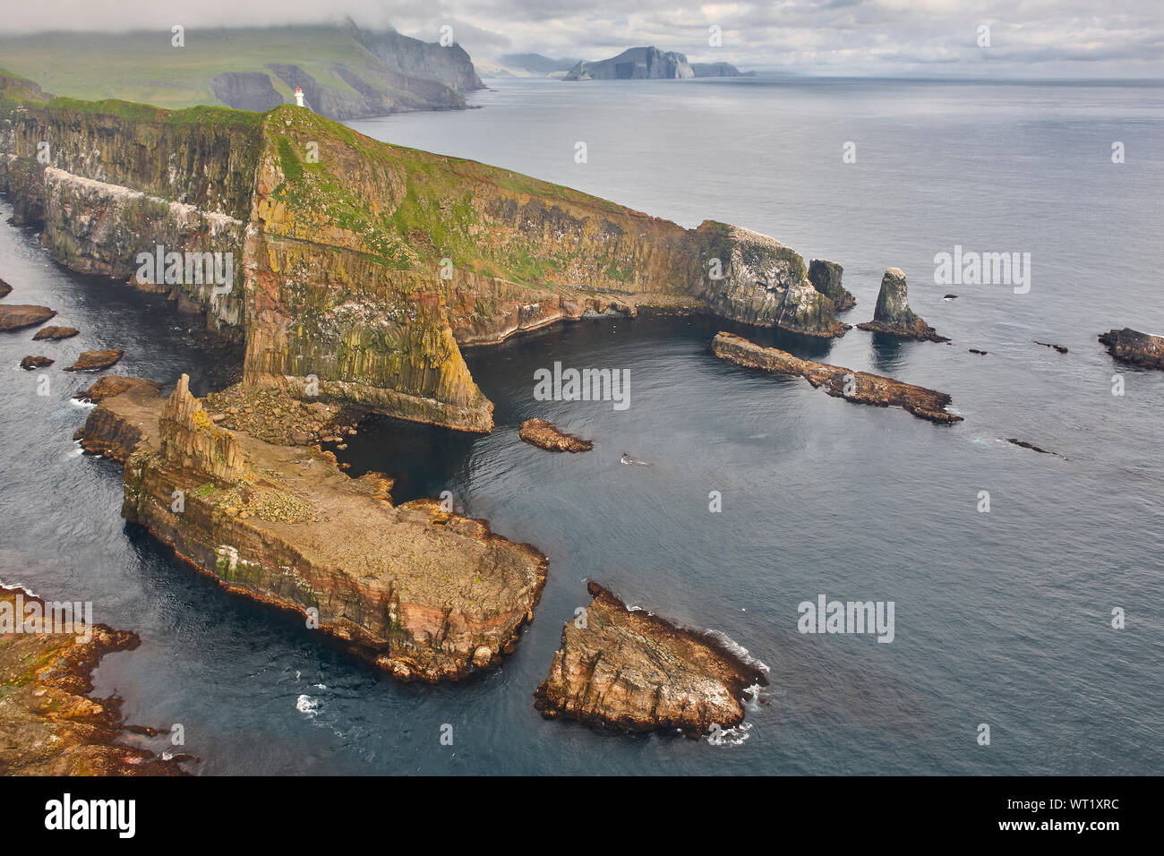 Mykines lighthouse and cliffs on Faroe islands from helicopter. Denmark ...