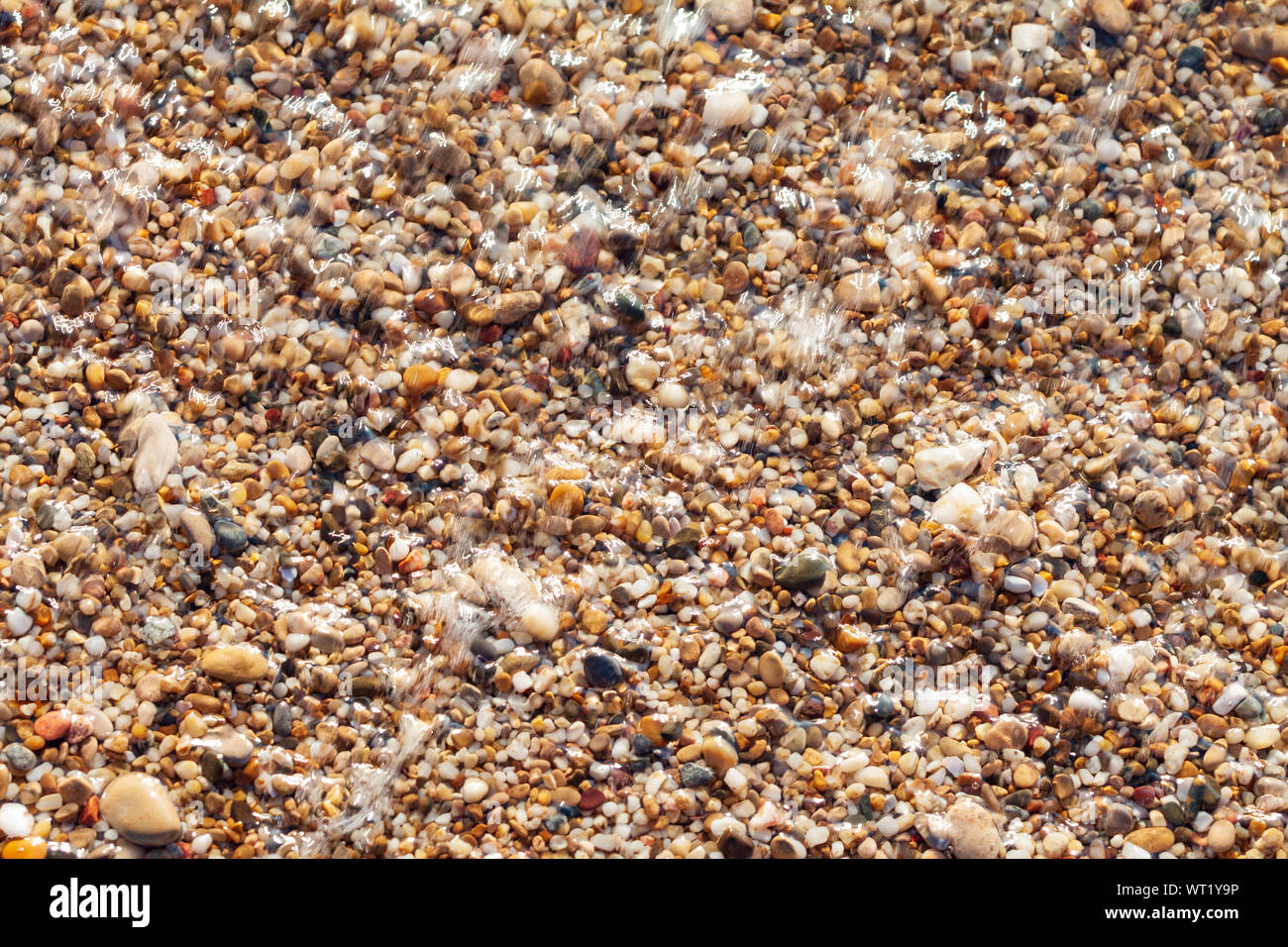 sea pebbles colored granite on the beach background stones. The shore ...