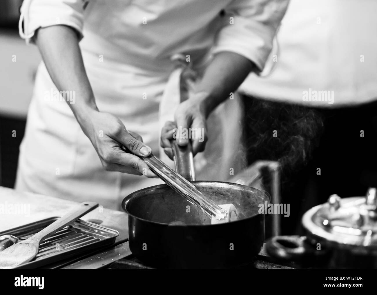 chef preparing food, chef cooking in a kitchen, chef at work, Black ...