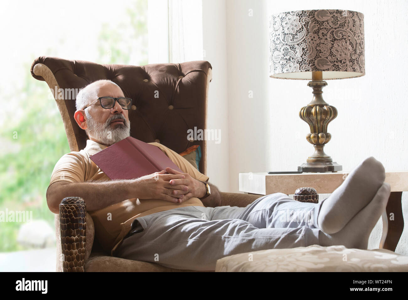 senior man sleeping while reading a book Stock Photo - Alamy