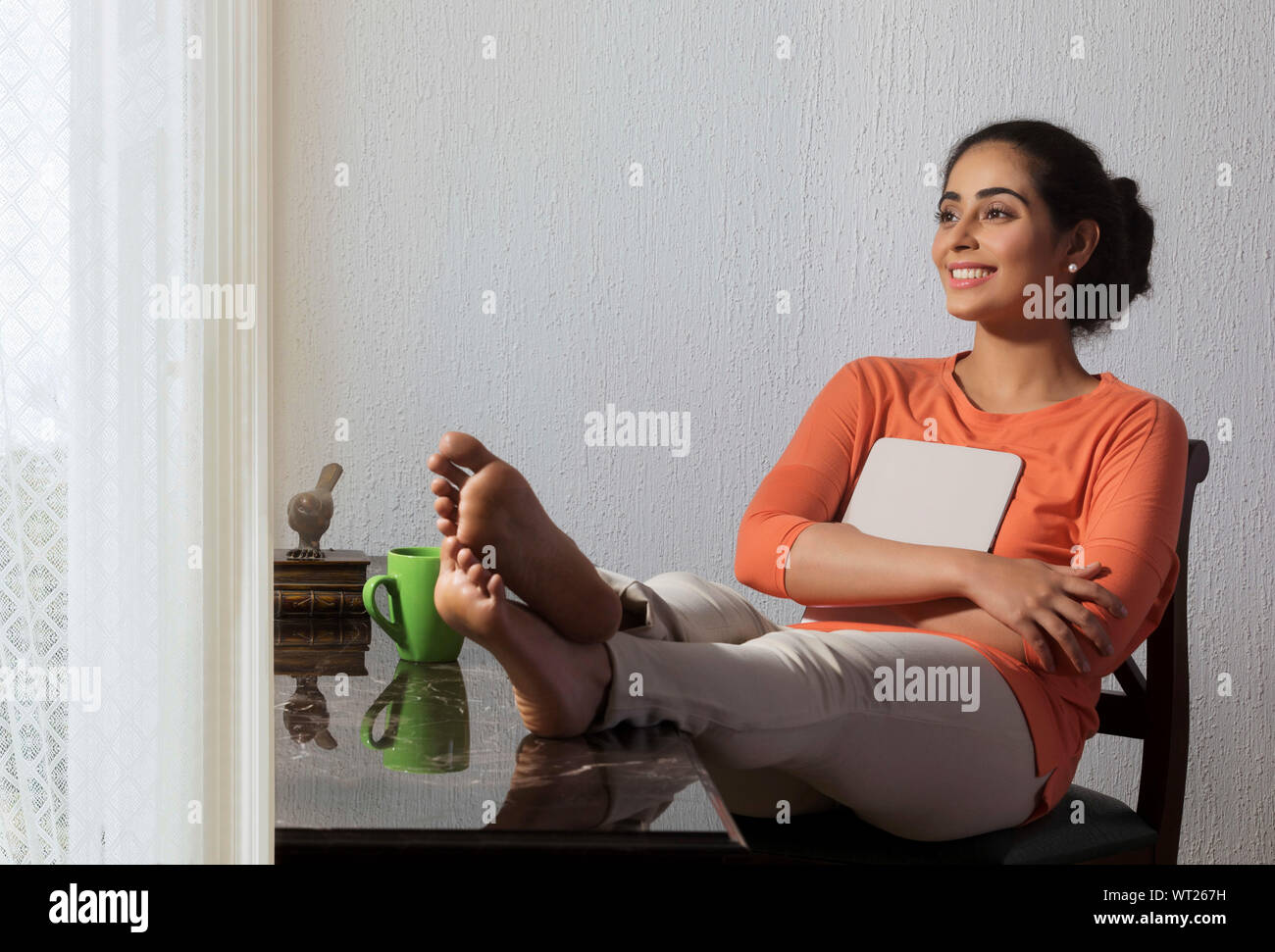 Woman looking outside living room hi-res stock photography and images ...
