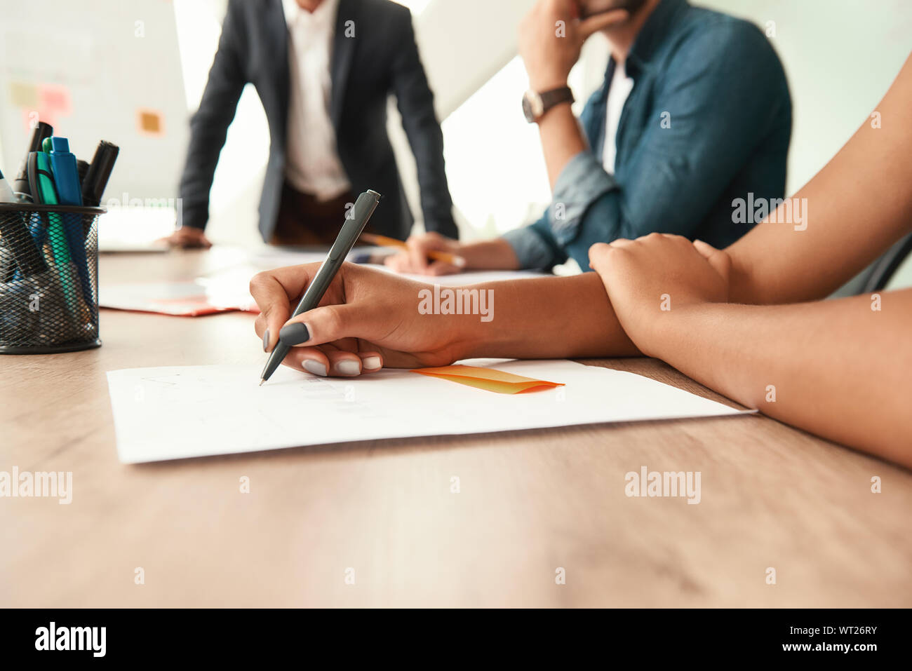 Making notes. Cropped view of a woman writing something down while ...