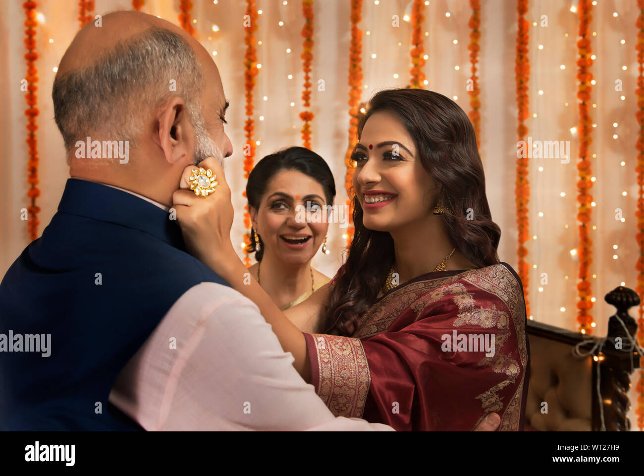 daughter pulling her fathers cheeks Stock Photo - Alamy