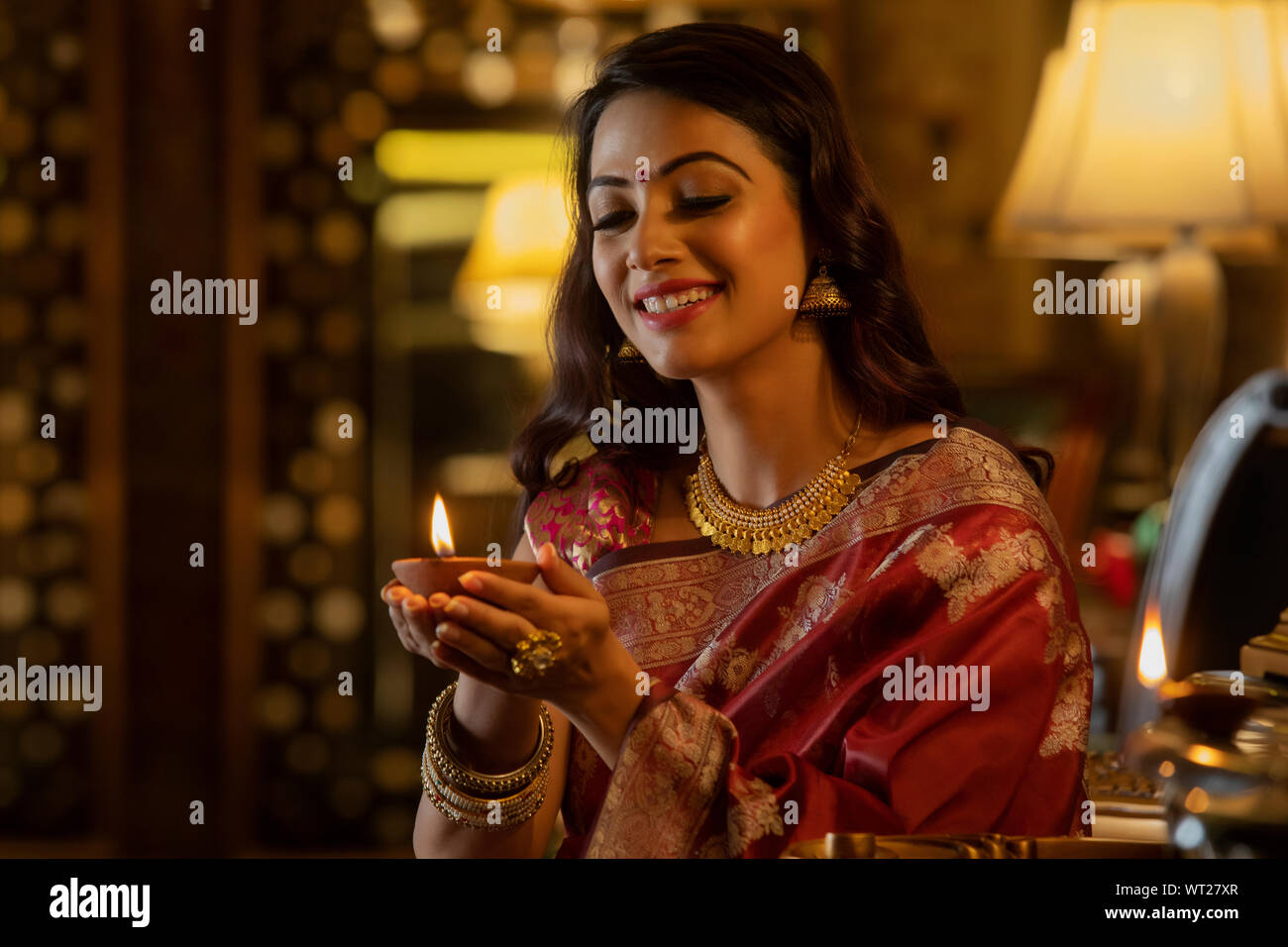 portrait of a woman with a diya Stock Photo - Alamy