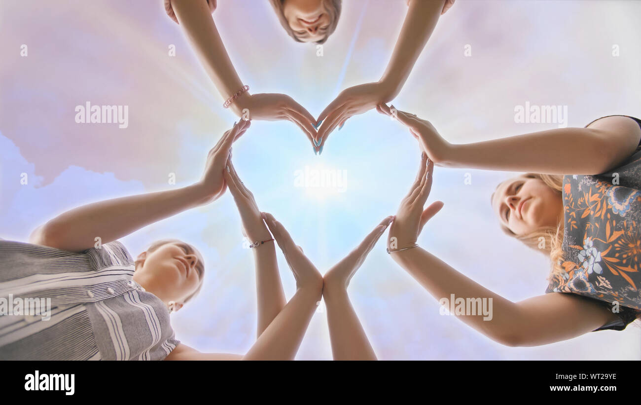 A group of youth makes a heart shape out of their hands Stock Photo - Alamy