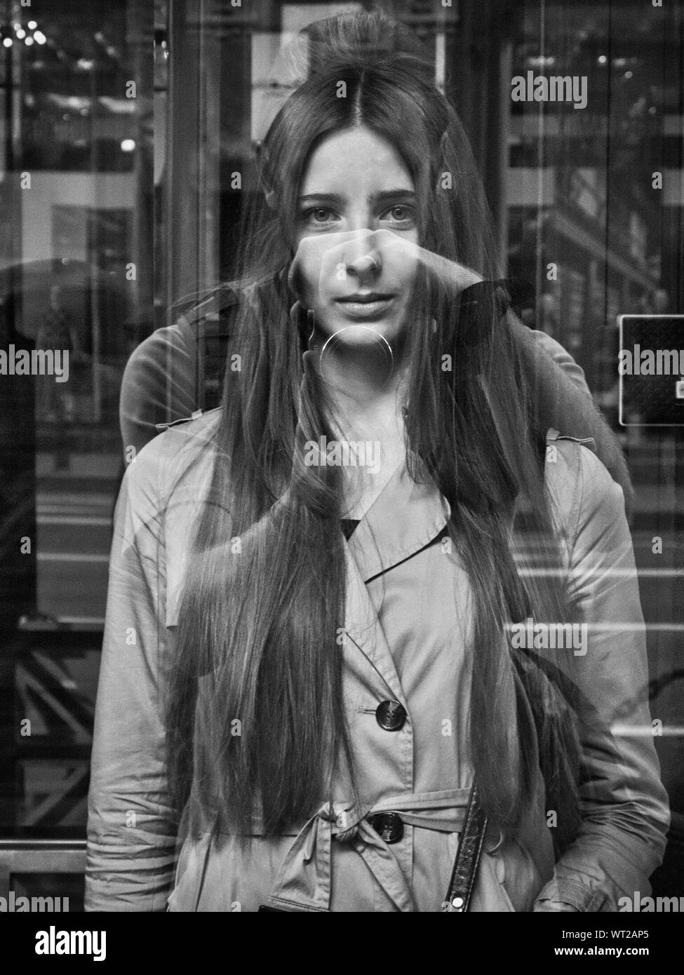 Woman looking at reflection in window Black and White Stock Photos ...