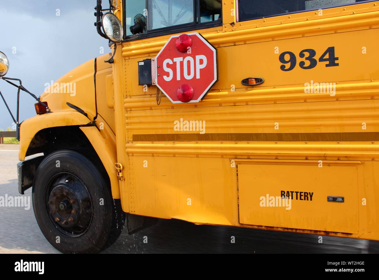 Yellow school bus with visible stop sign in rainy weather Stock Photo ...