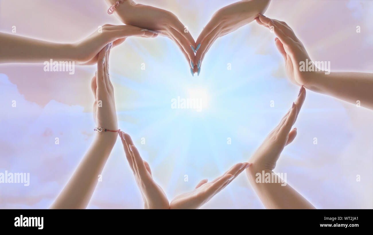 A group of youth makes a heart shape out of their hands Stock Photo - Alamy