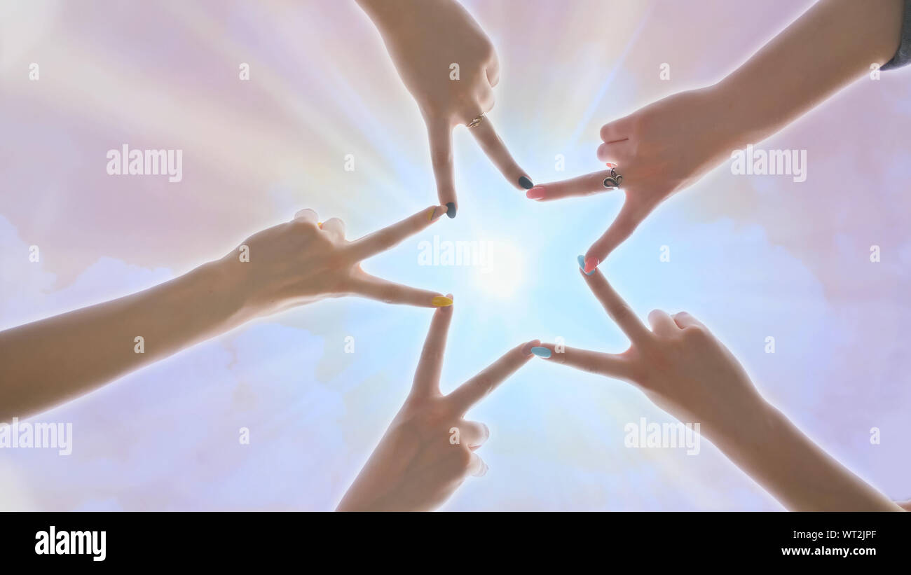 People forming star shape with their fingers against the backdrop of a ...