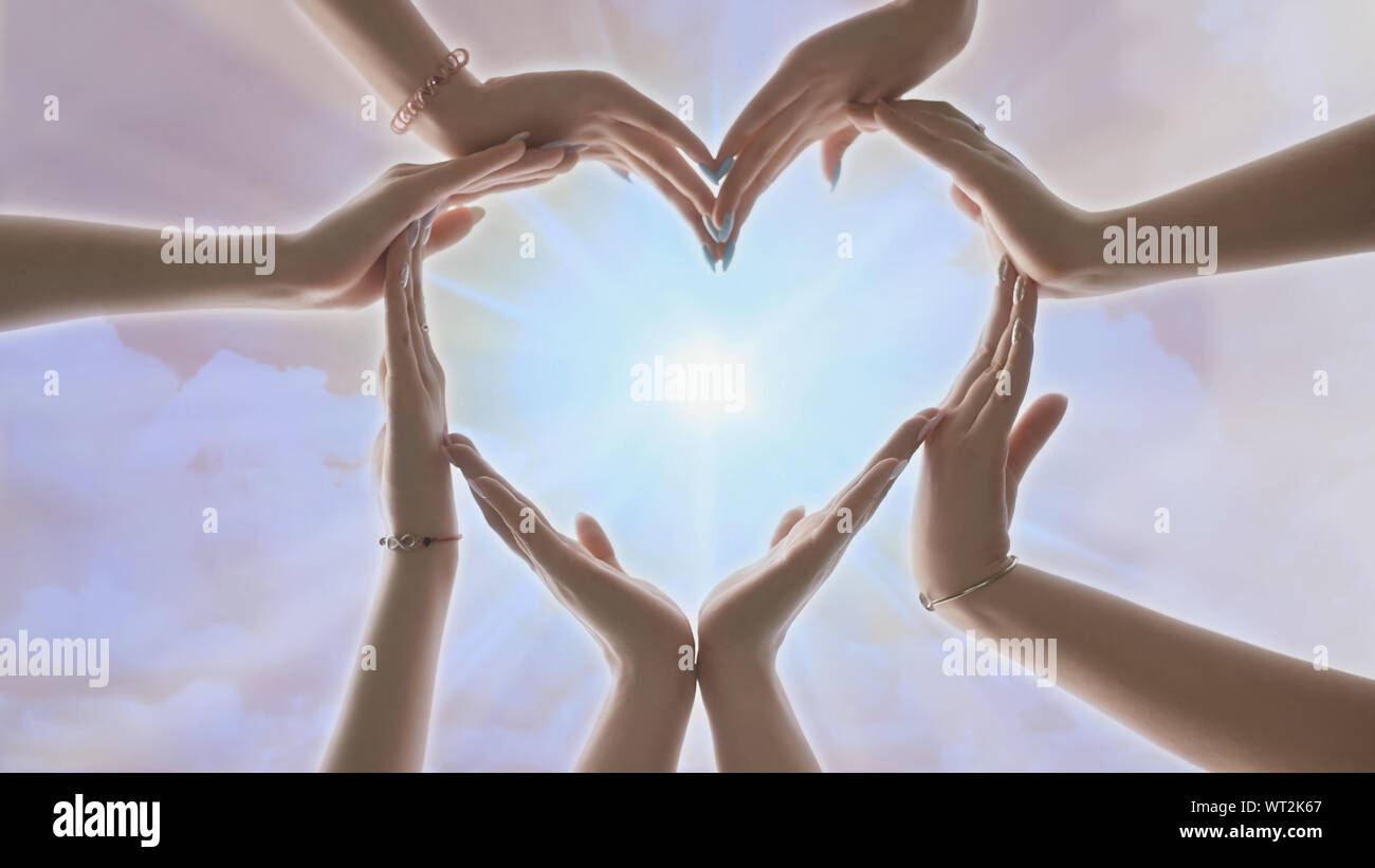 A group of youth makes a heart shape out of their hands Stock Photo - Alamy