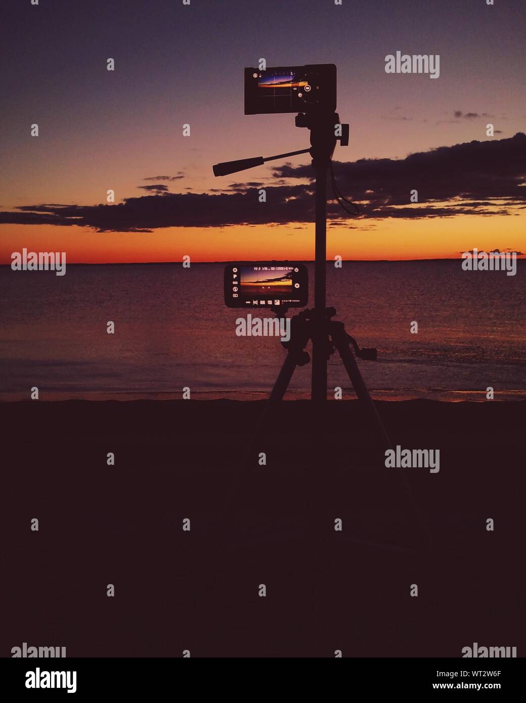 Digital Cameras On A Tripod Taking A Picture Of Sea Stock Photo - Alamy