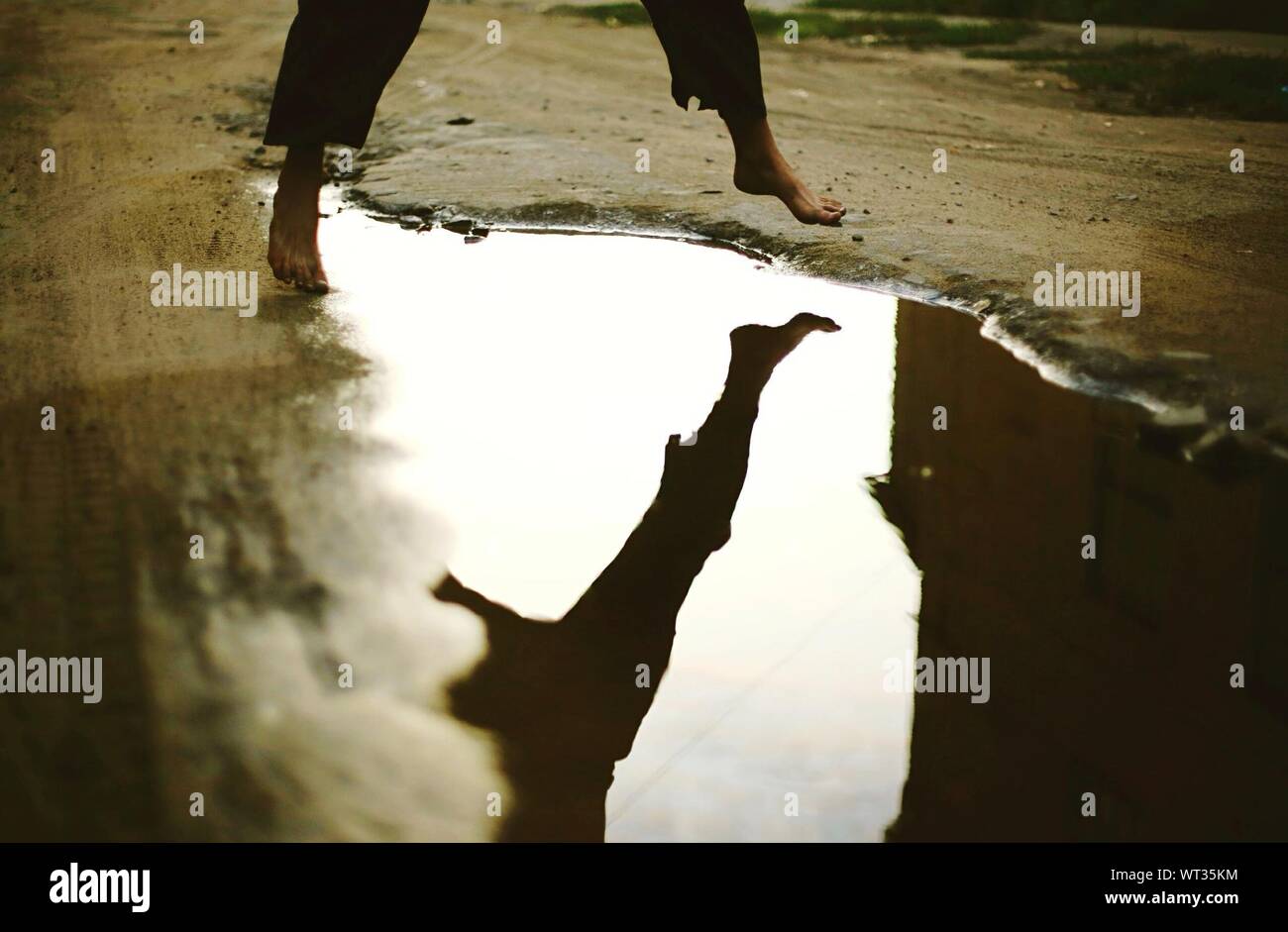 Jumping over puddle hi-res stock photography and images - Alamy