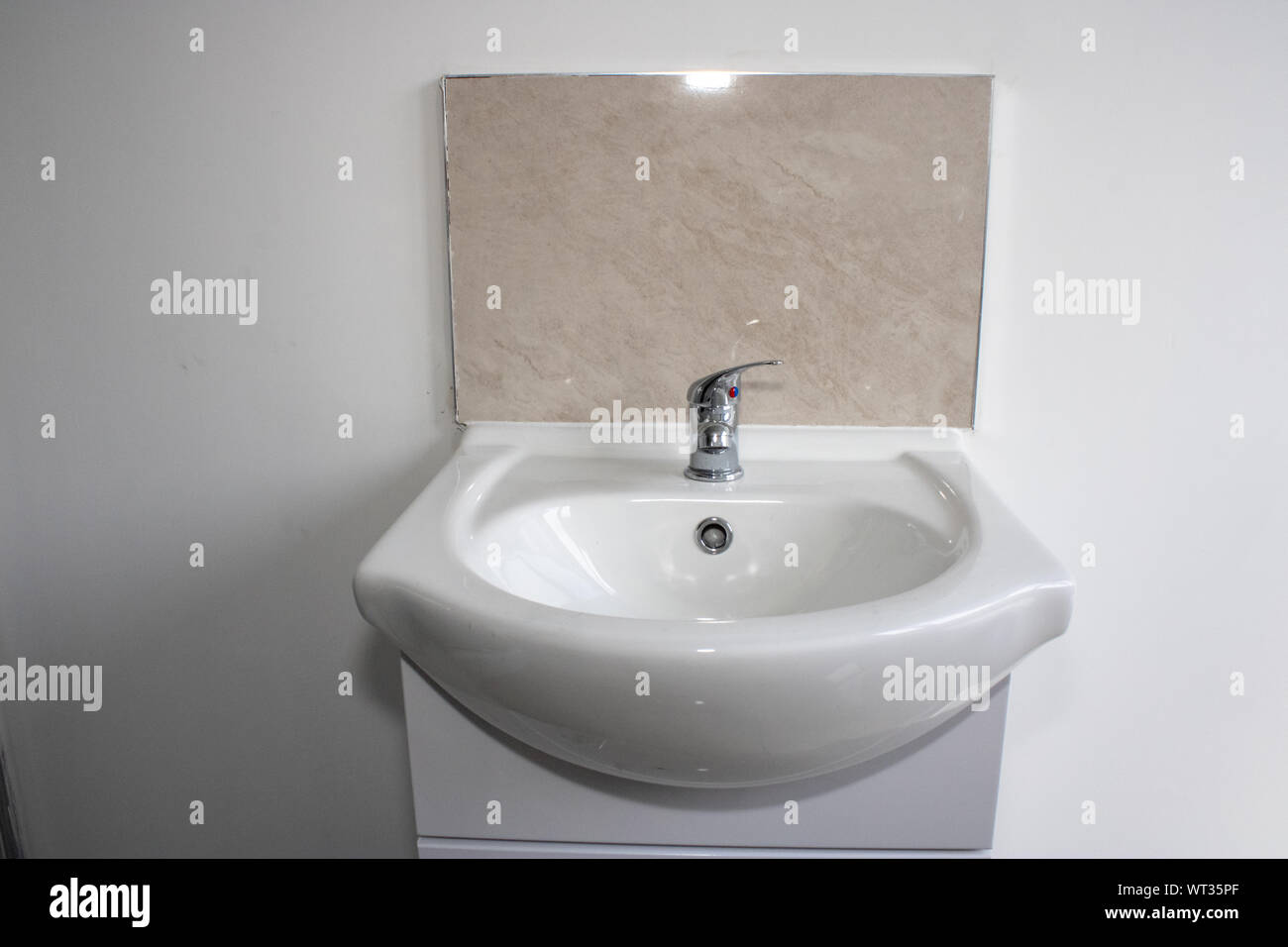 A typical UK British brand new bathroom sink with tile background Stock ...