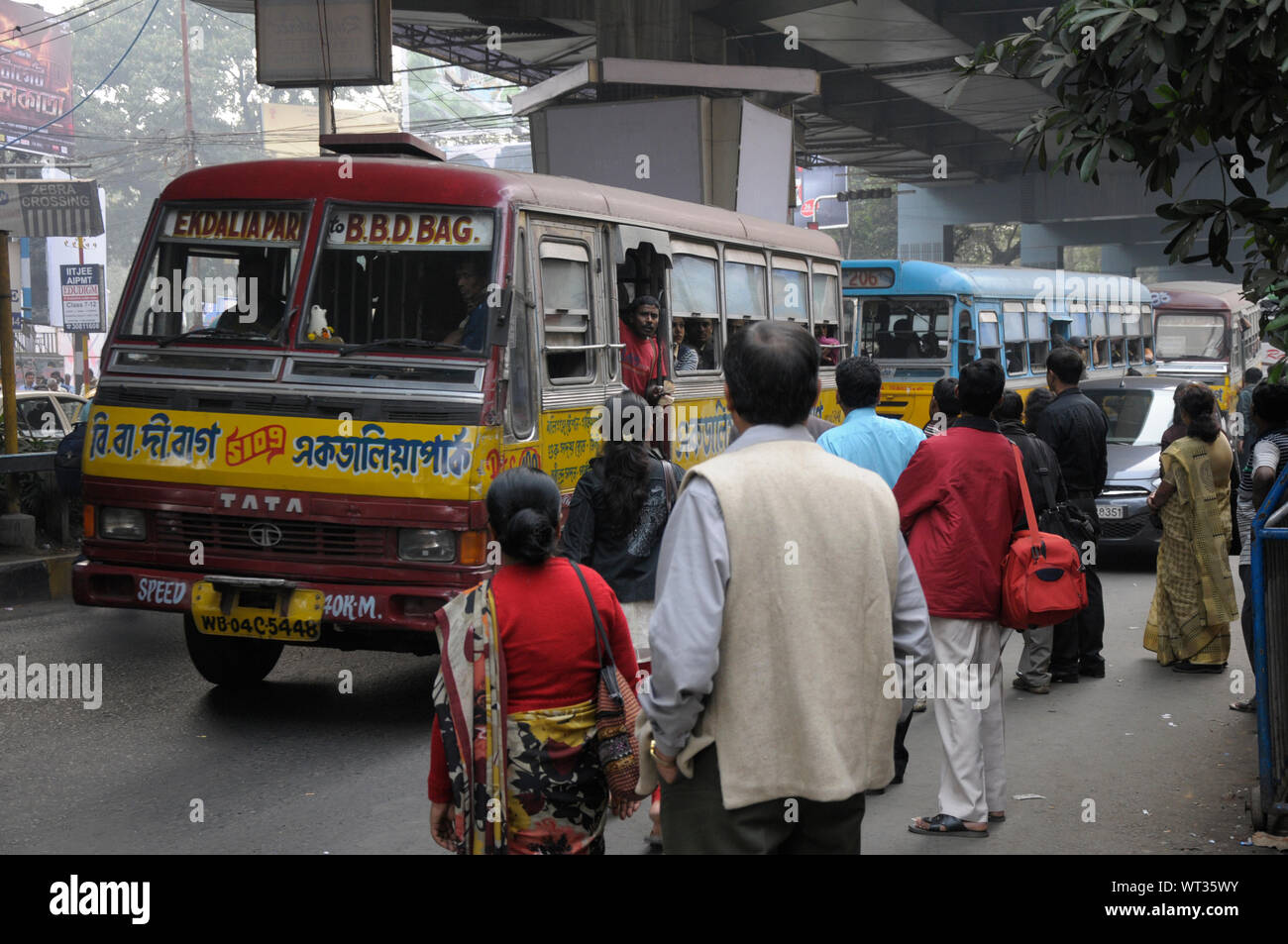 Padestrians cover a section of a busy street intersection trying to ...
