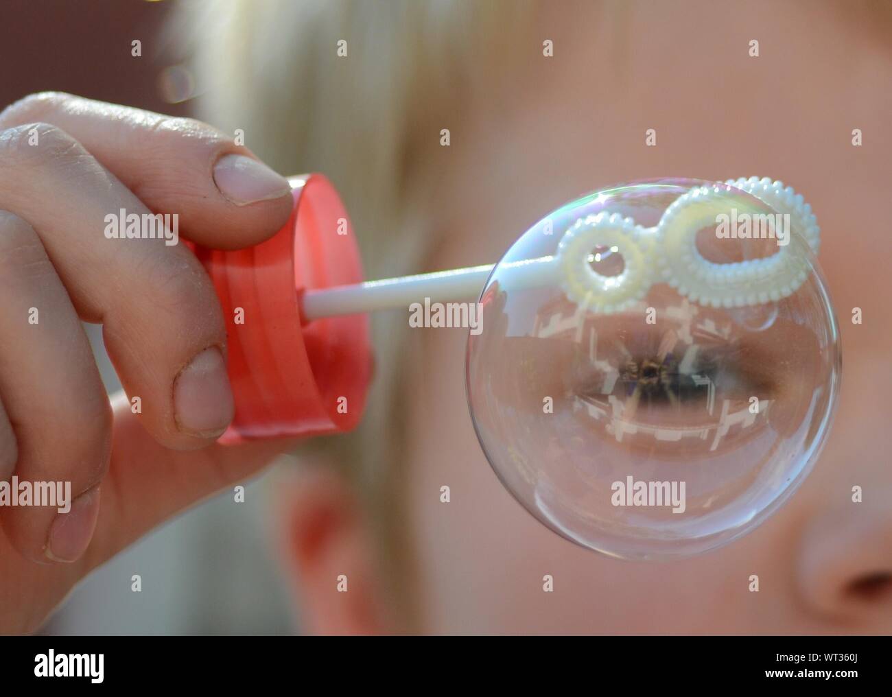 Hand holding bubble wand hi-res stock photography and images - Alamy