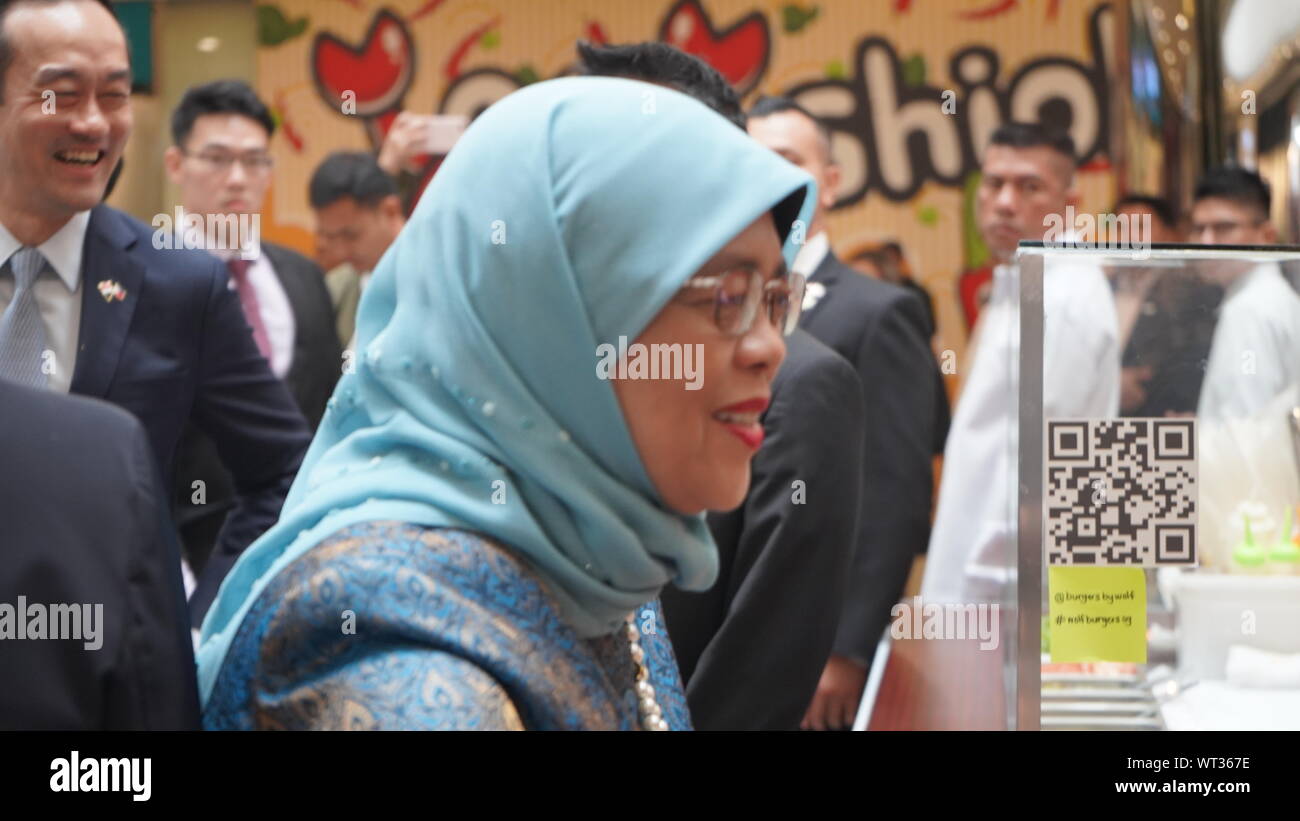 Singapore President Halimah Yacob (blue head scarf) and her husband ...