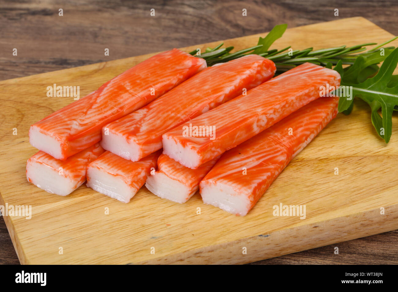 Crab stick surimi over wooden board Stock Photo - Alamy