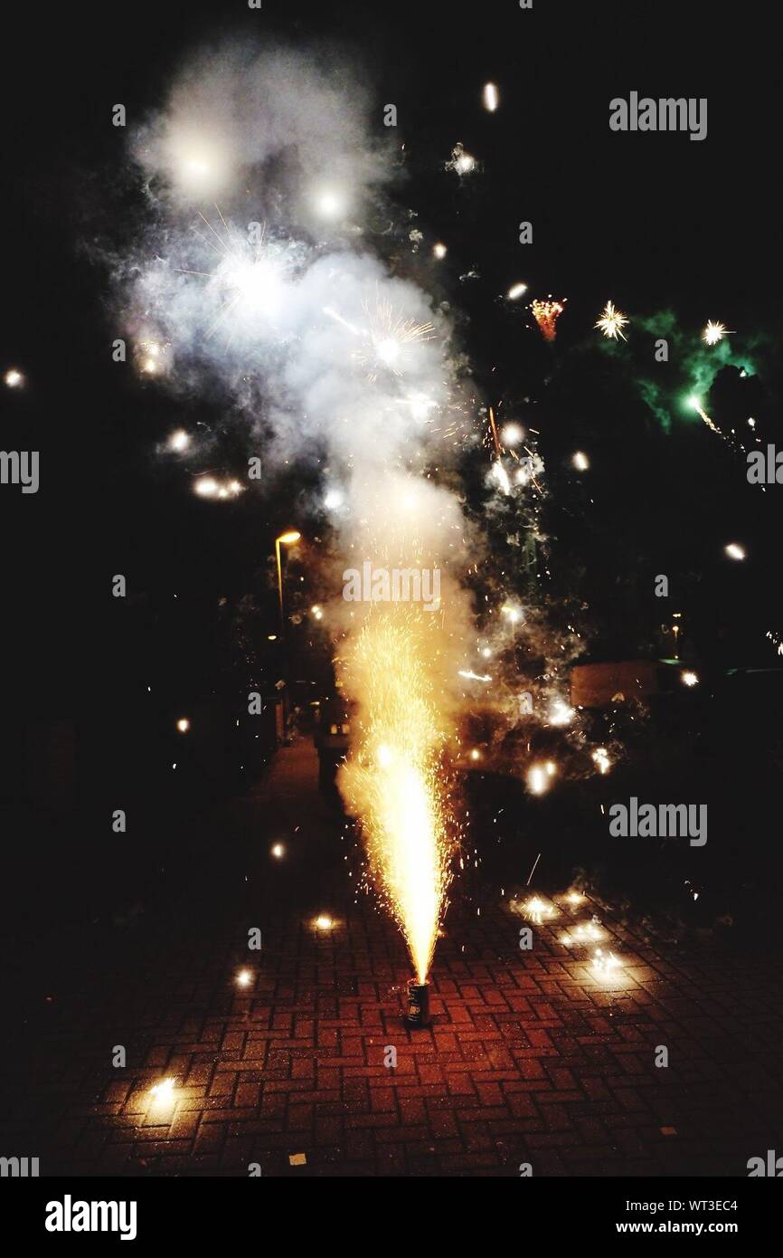 Lit Firework On Street At Night Stock Photo - Alamy