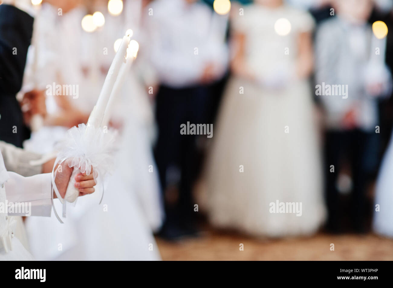 Young girl in white hold candle in hand at first holy communion Stock ...