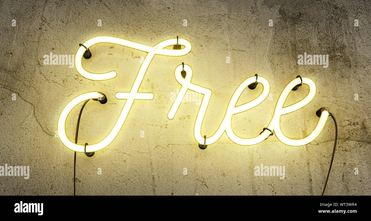 Bright white neon sign lamp saying the word Free on a grunge concrete ...