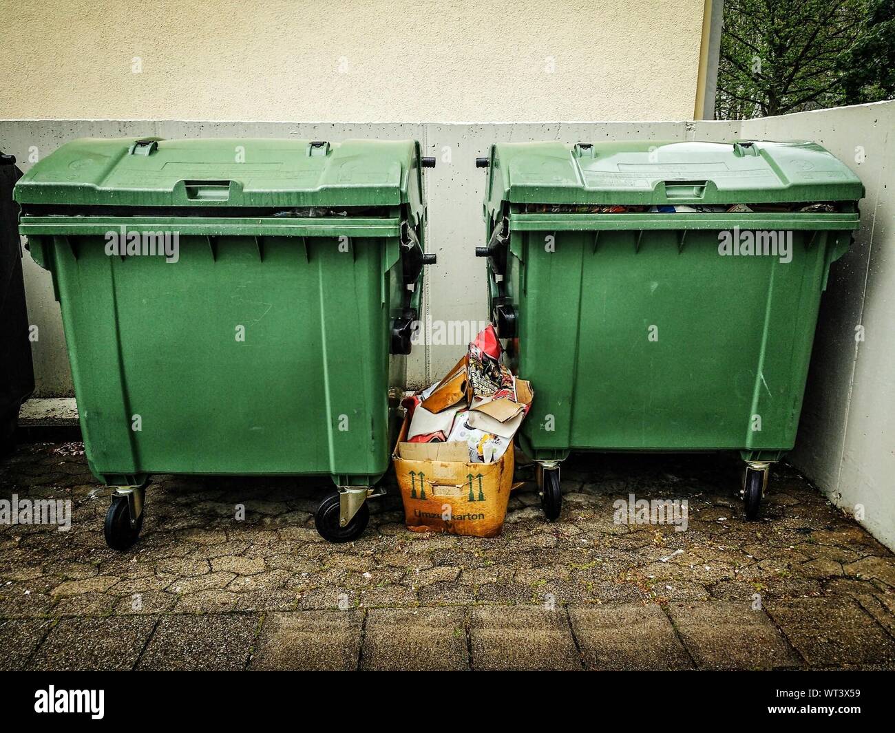 Garbage Cans Against Wall Stock Photo - Alamy