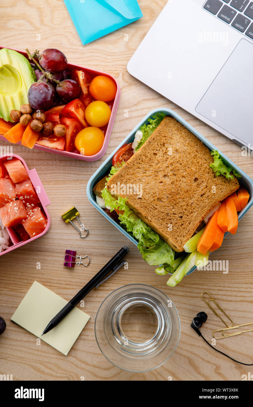 Flat lay with healthy lunch dishes variety: sandwich, salad and fruit ...