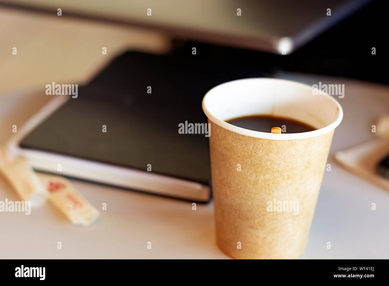 Hot coffee in a recycled paper container. Coffee break in the office ...