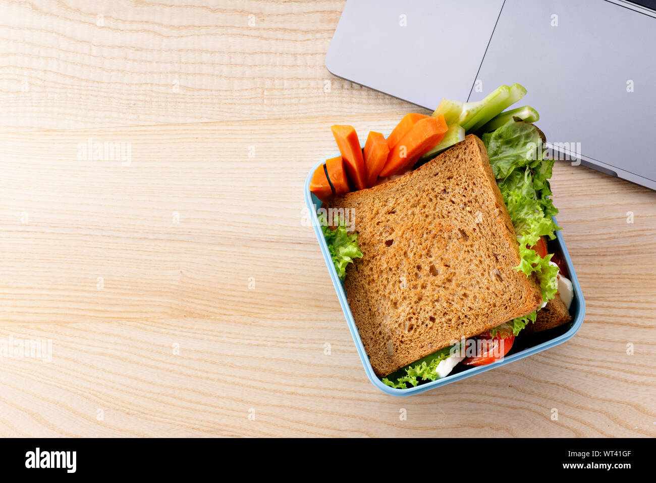 Flat lay with healthy sandwich in plastic container on wooden table ...