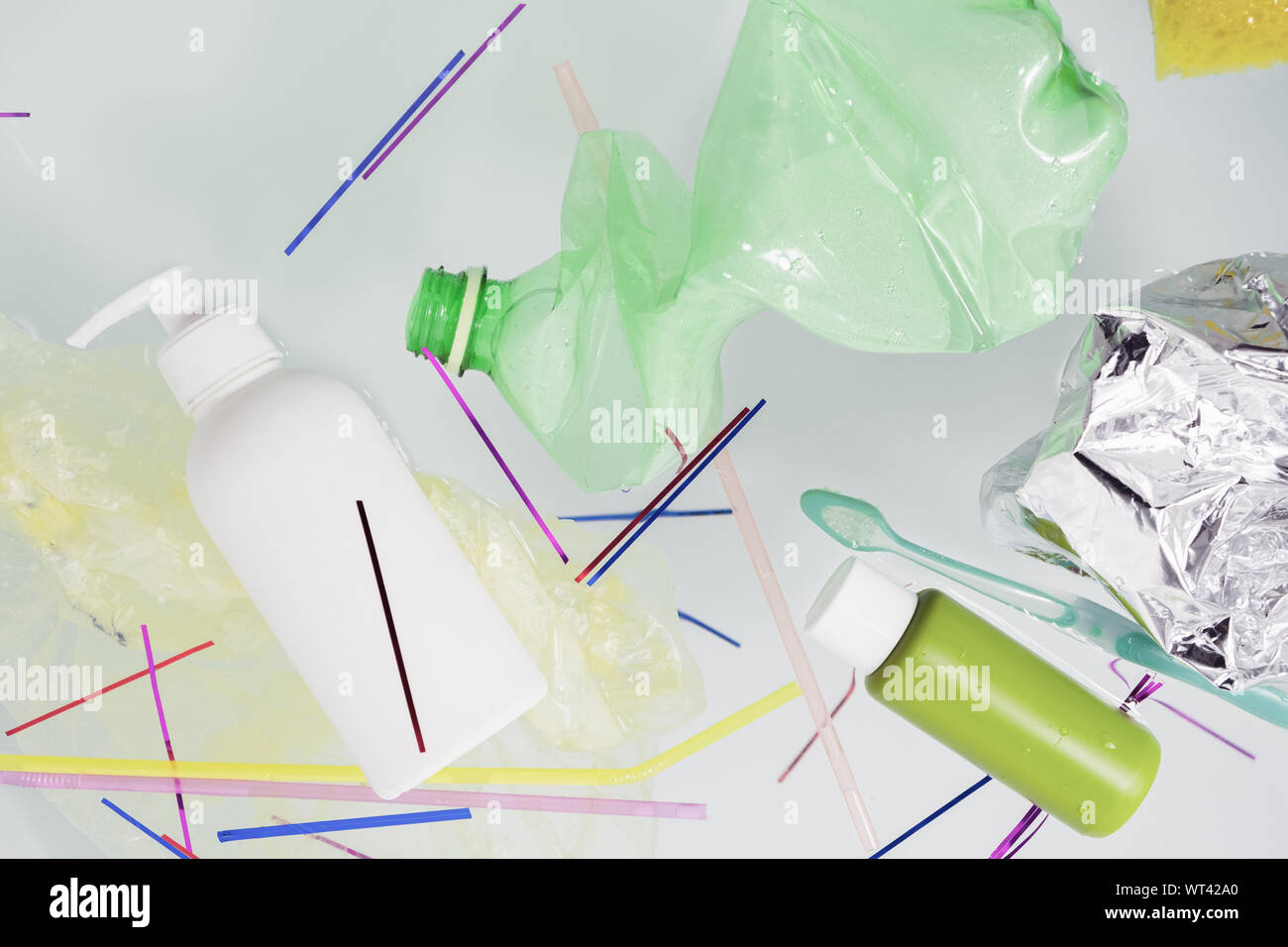 Plastic trash floats on the surface of the water in the bathtub. The ...