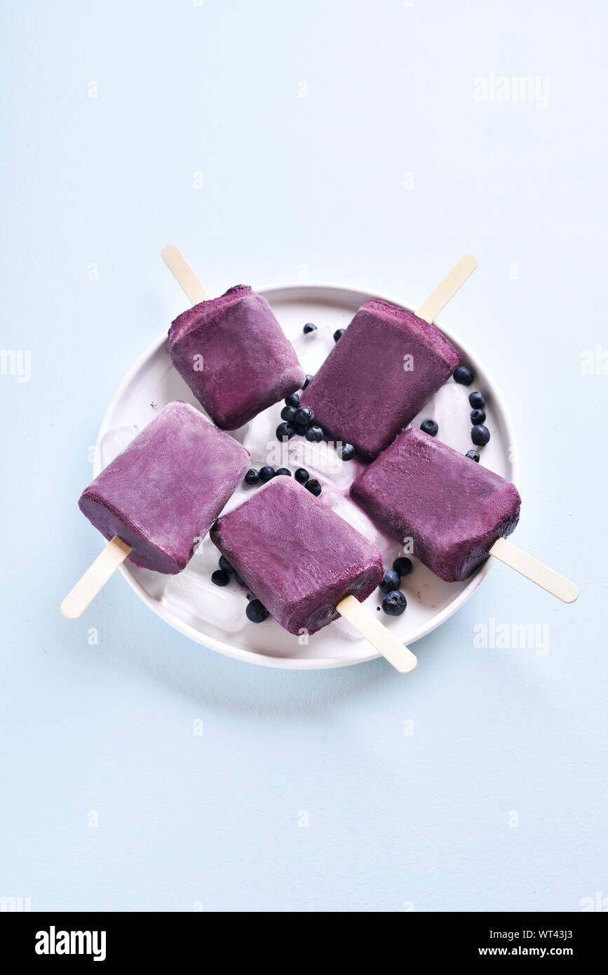 Blueberry popsicles on blue stone background with free space. Cold ...