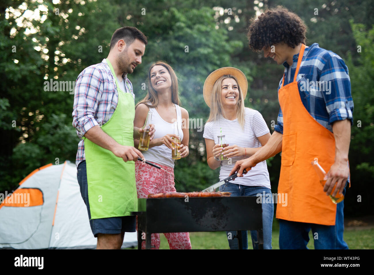 Group of friends having a barbecue party in nature Stock Photo - Alamy