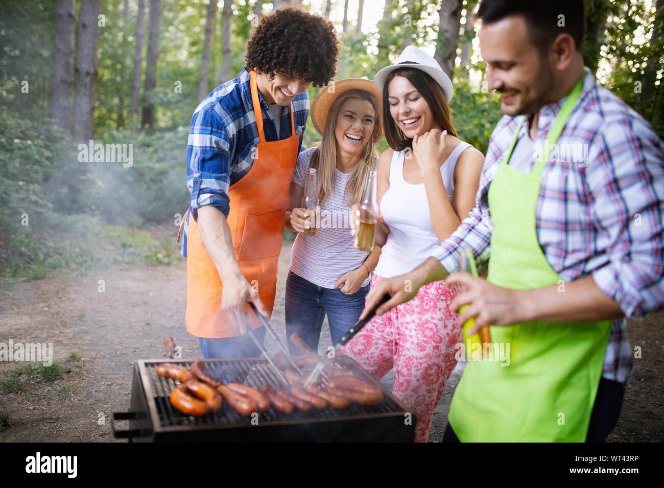 Group of friends having a barbecue and grill party in nature Stock ...