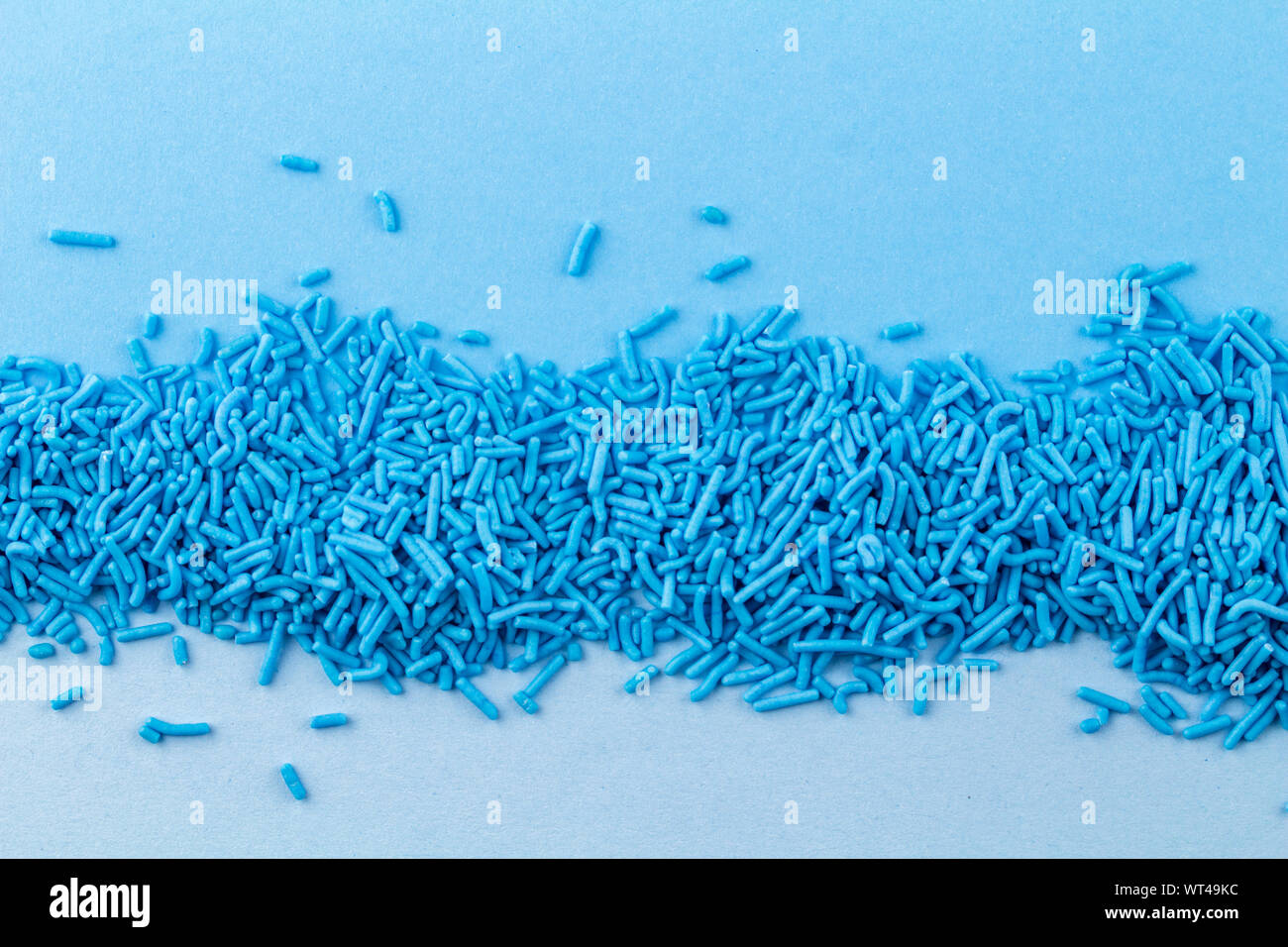Blue cake topping sprinkles on blue background - Abstract sprinkle ...