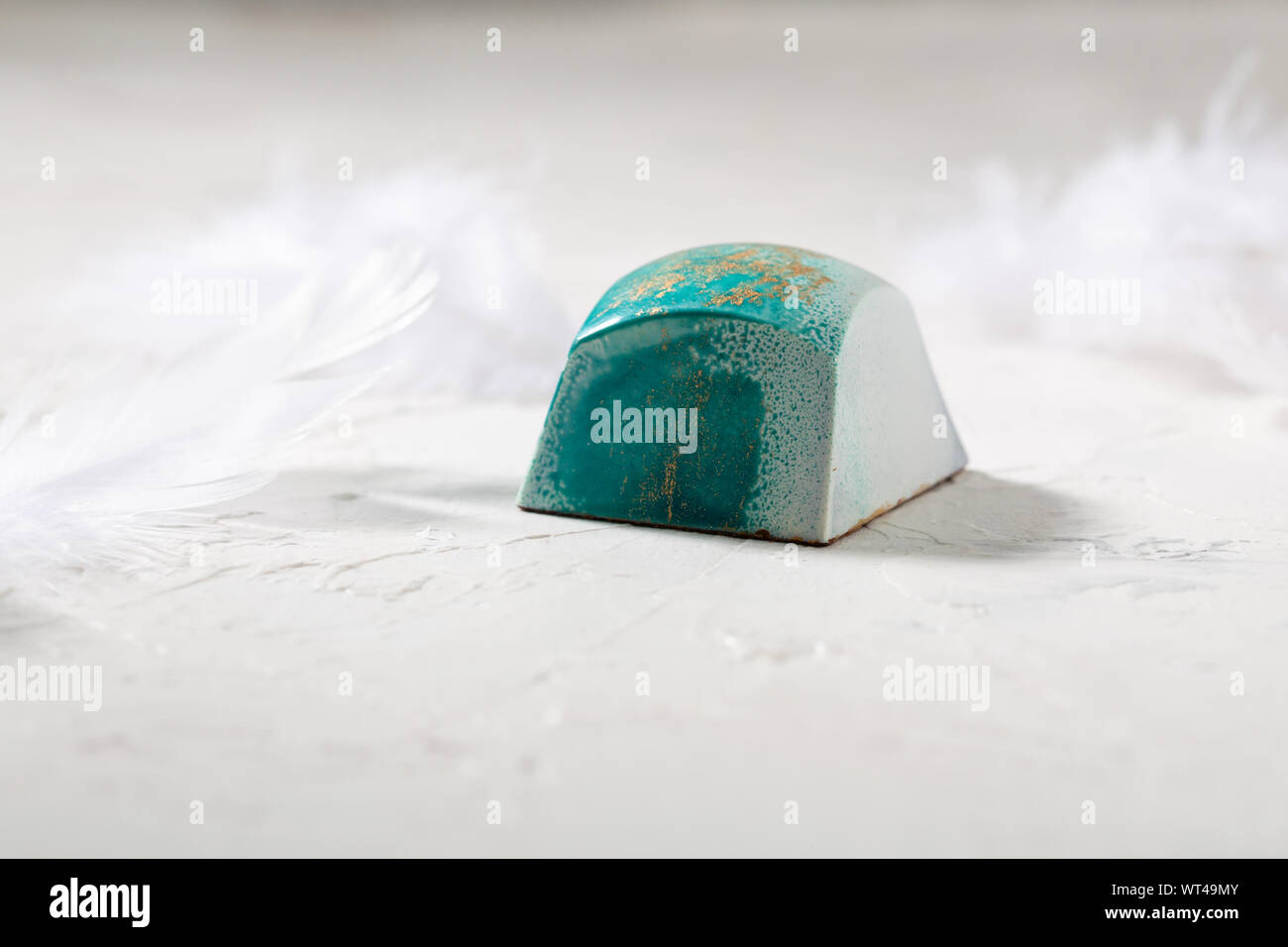 One modern chocolate candy close-up on white Stock Photo - Alamy