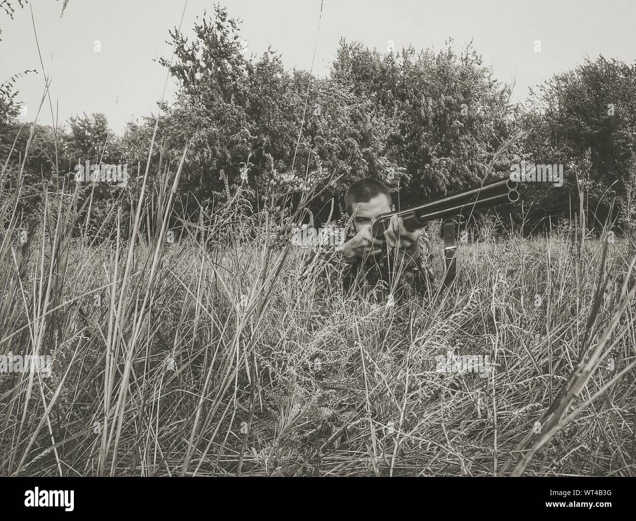 Young man aiming gun hi-res stock photography and images - Alamy