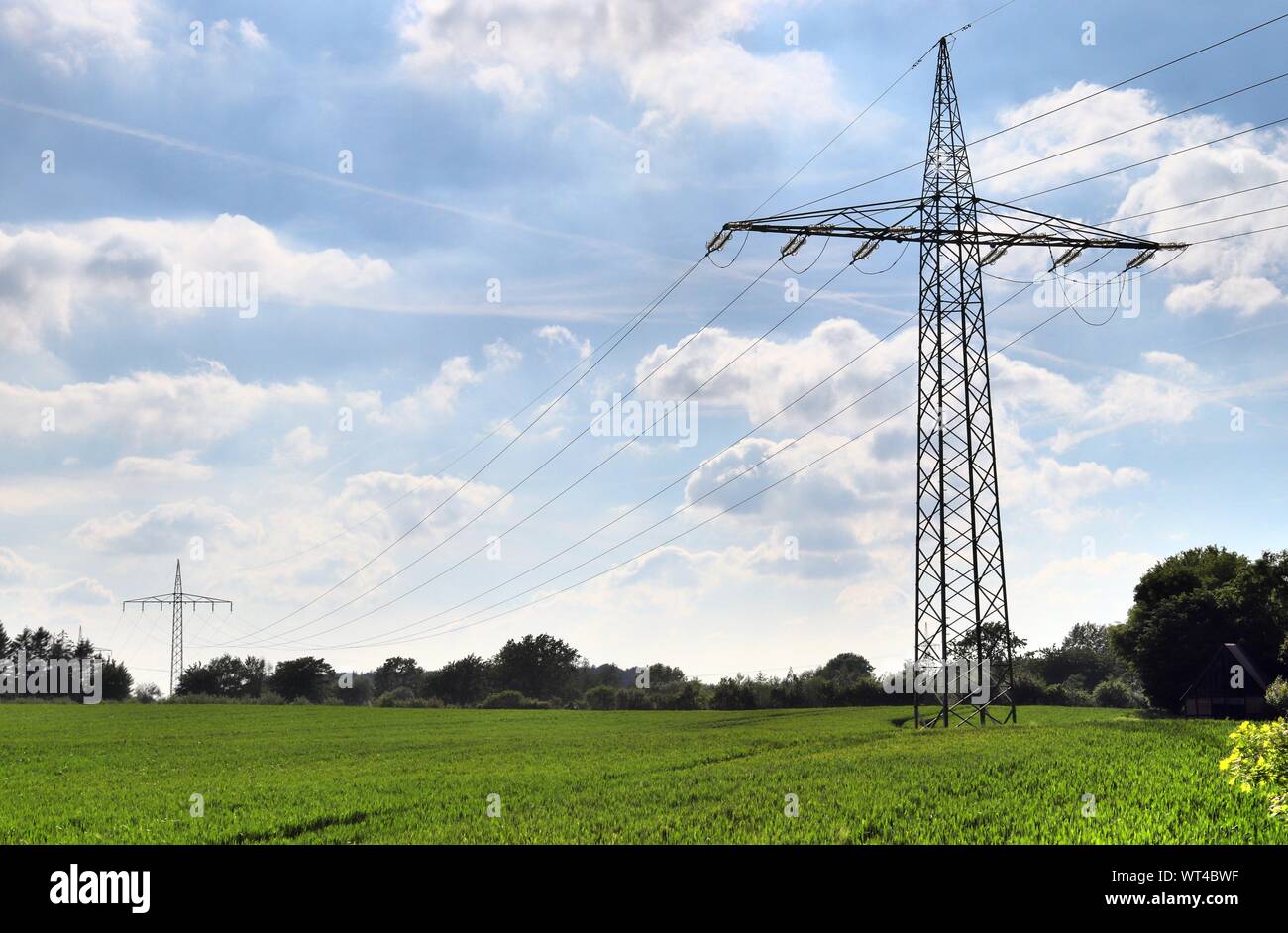 Close up view on a big power pylon transporting electricity in a ...
