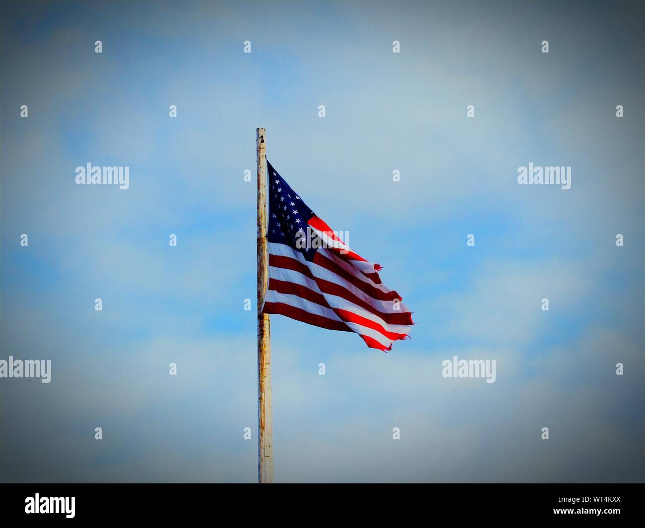 American flag waving blue sky hi-res stock photography and images - Alamy