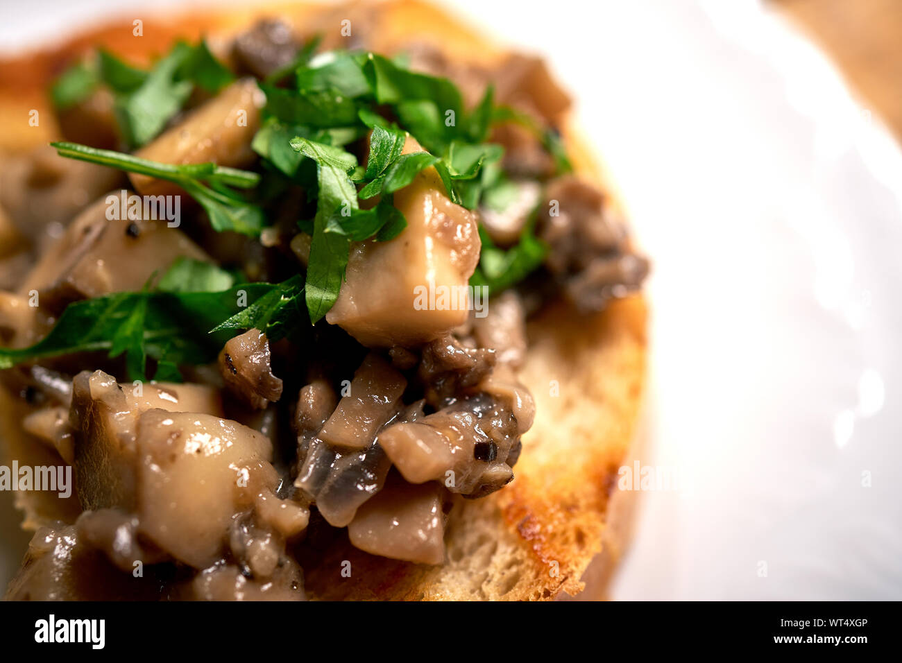 Close up of toasts with mushrooms on wooden kitchen table Stock Photo ...