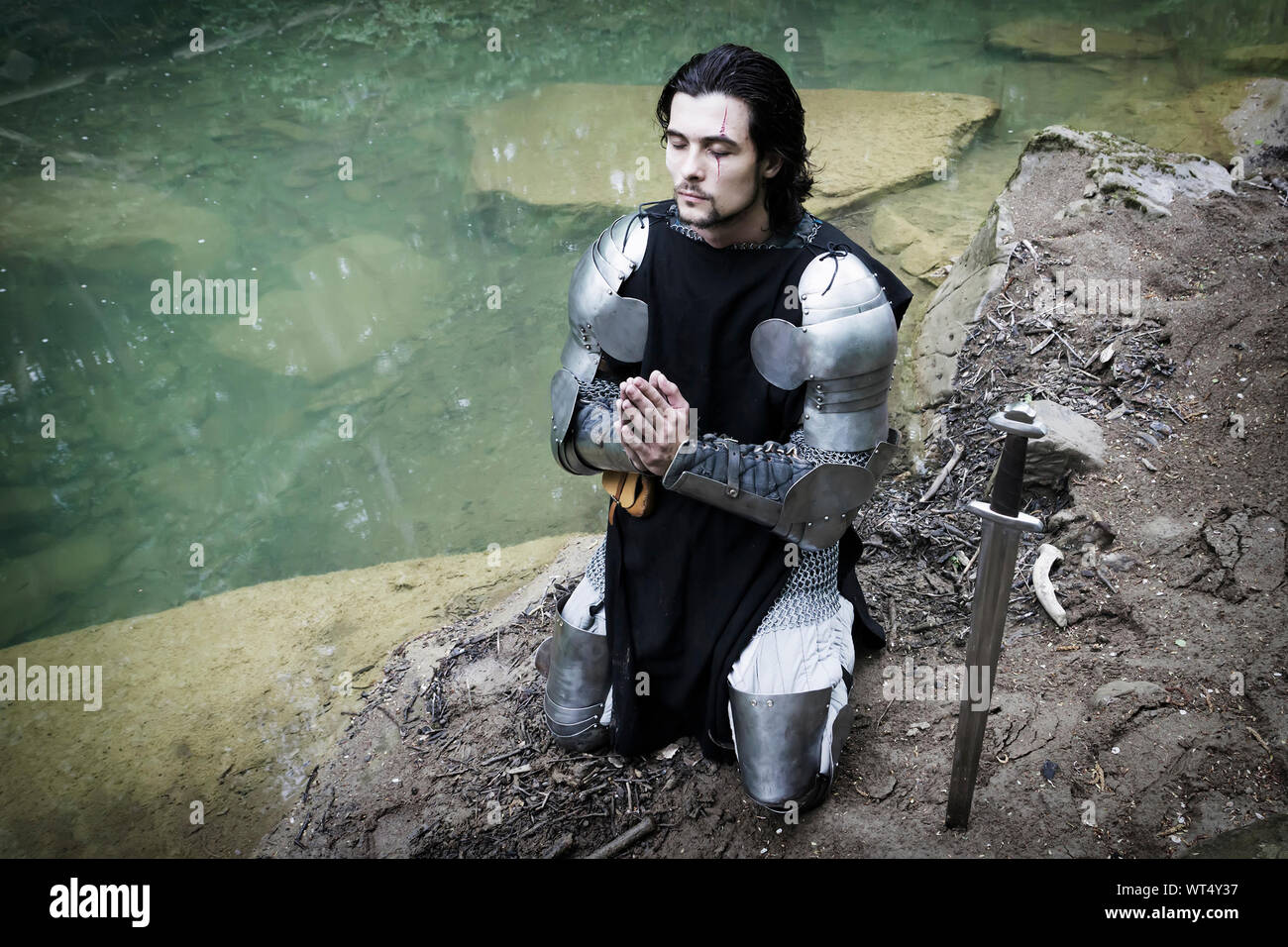 Kneeling praying in suit hi-res stock photography and images - Alamy