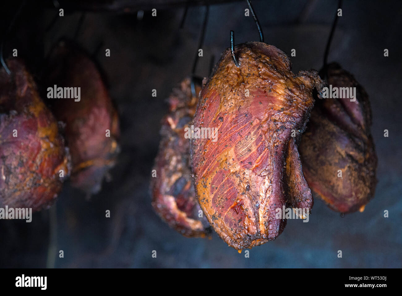 Smoked pork meat in smoker on dark background Stock Photo - Alamy