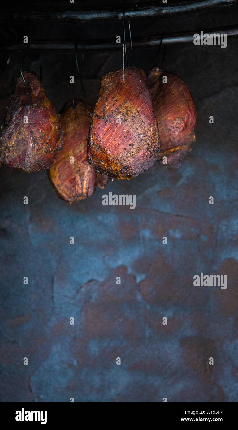Smoked pork meat in smoker on dark background Stock Photo - Alamy