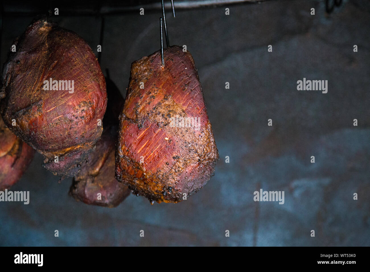 Smoked pork meat in smoker on dark background Stock Photo - Alamy