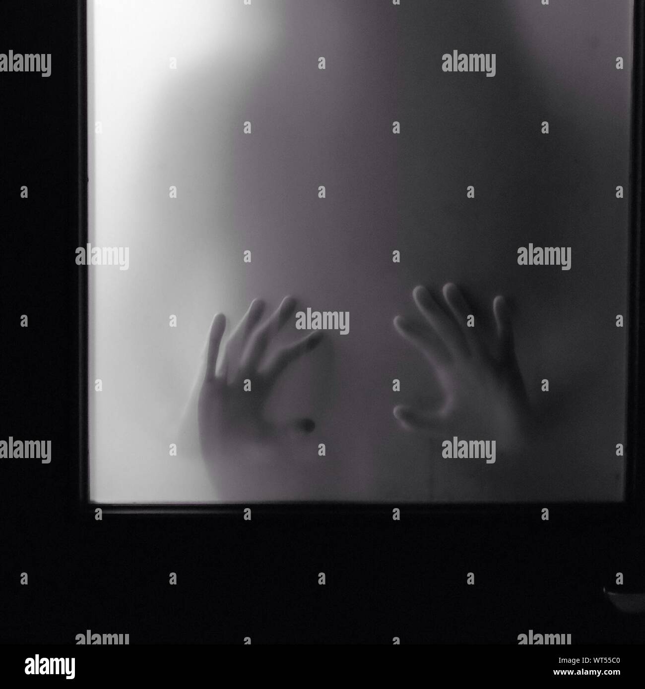 Touching hands through glass hi-res stock photography and images - Alamy