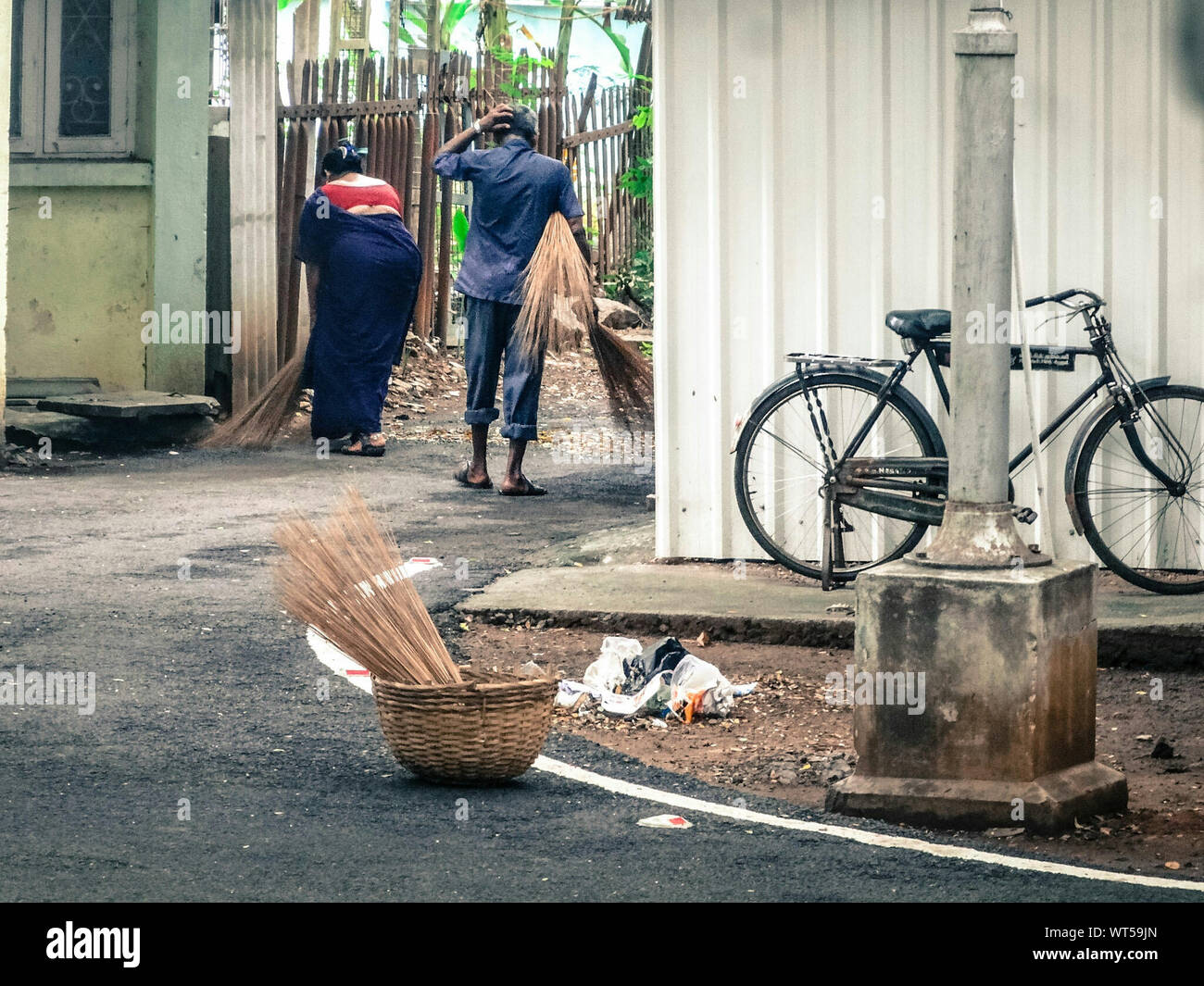 Indian man sweeping road hi-res stock photography and images - Alamy