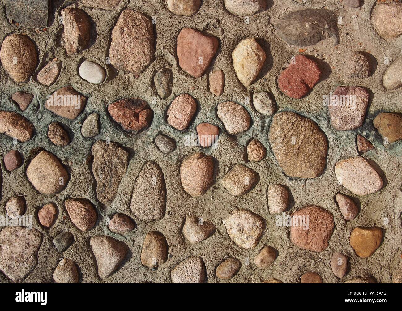 Wall made from concrete and stones, can be used as a background Stock ...