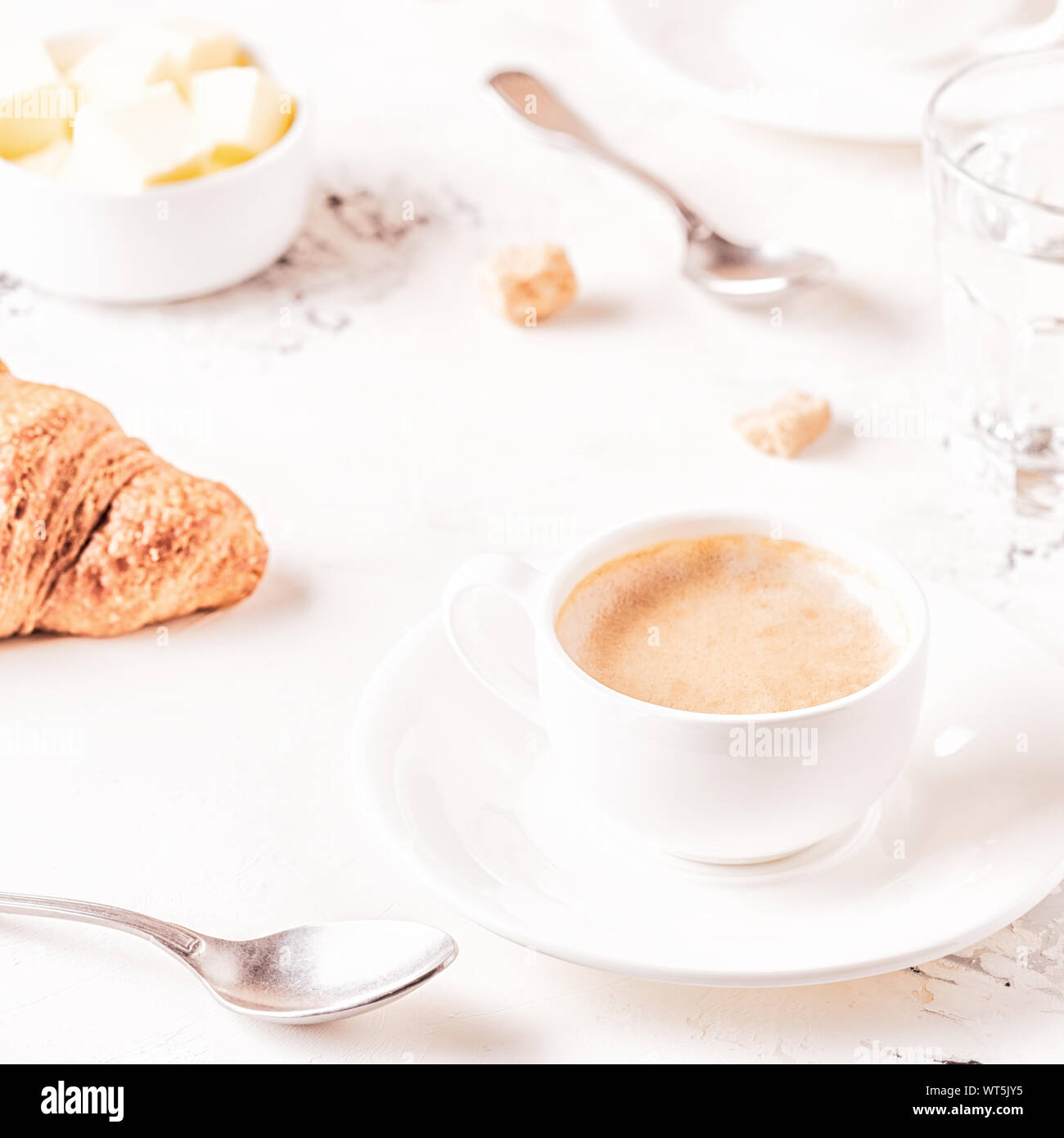 Traditional breakfast with fresh croissants on white background ...